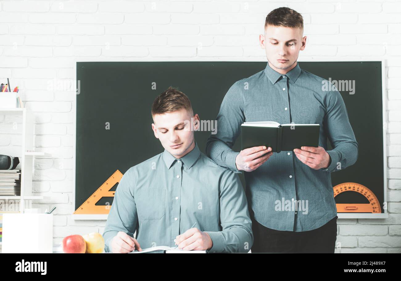 Brother support. Twin boys in uniform on lesson. Brothers in college or ...