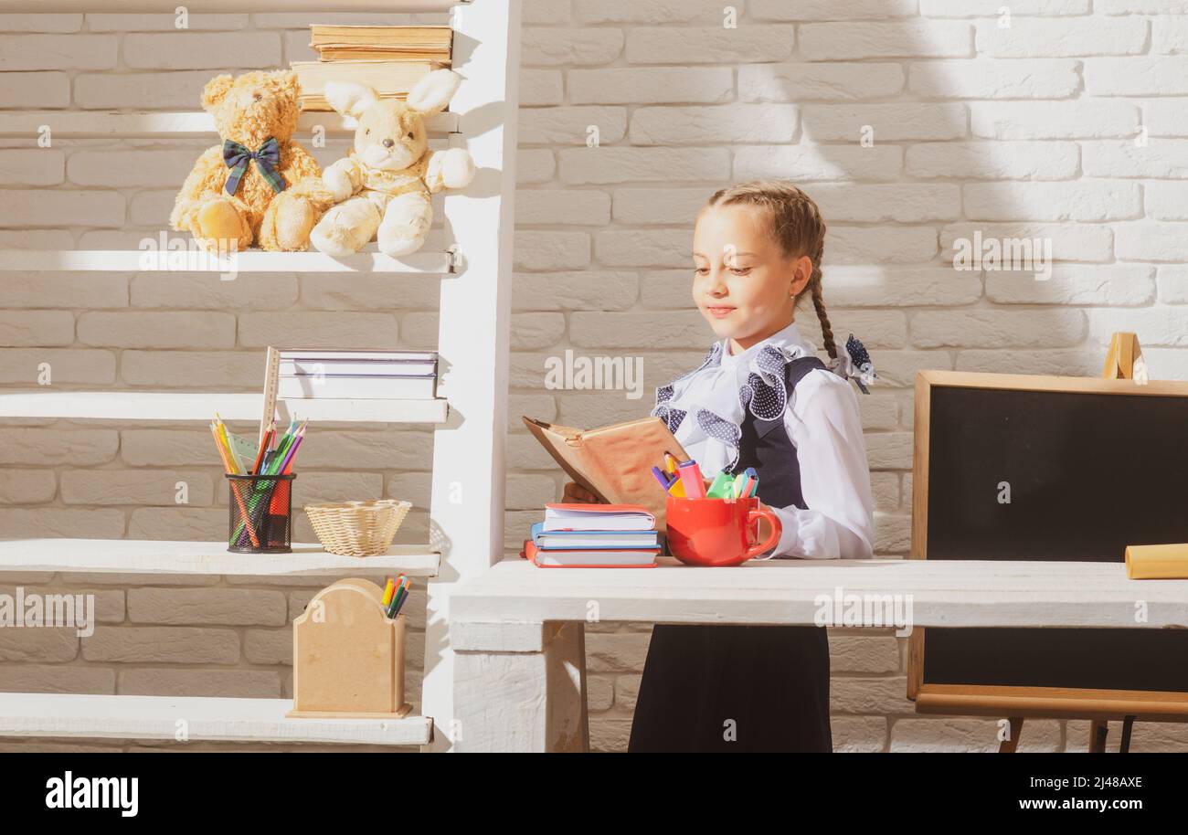 Schoolgirl studying homework math during lesson at classroom, education ...