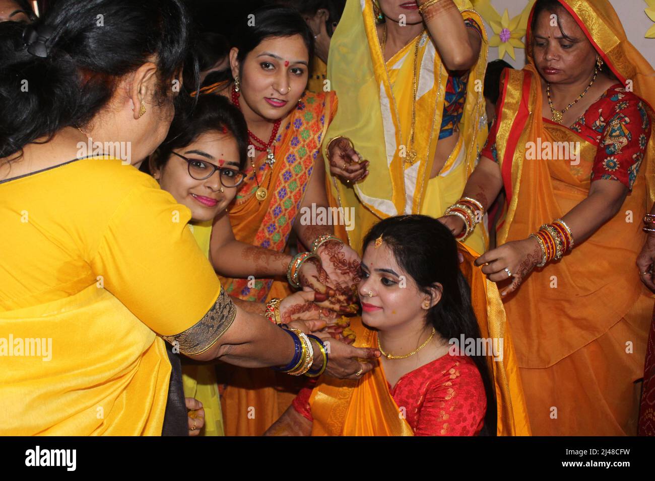 Indian Hindu bride with turmeric paste applied on her face having fun ...