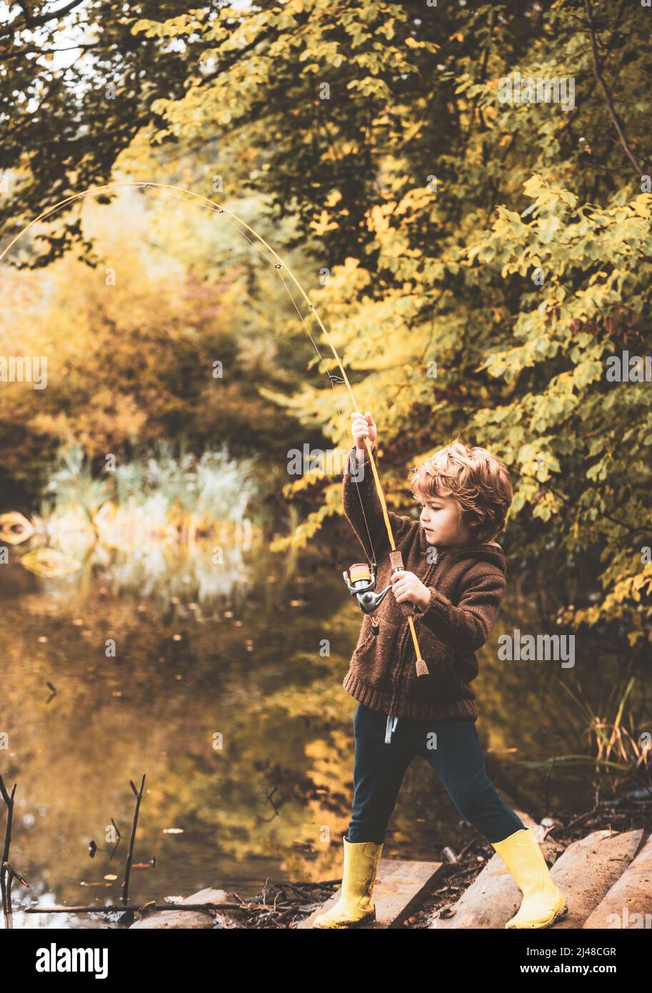 Photo of kid pulling rod while fishing on weekend Stock Photo - Alamy