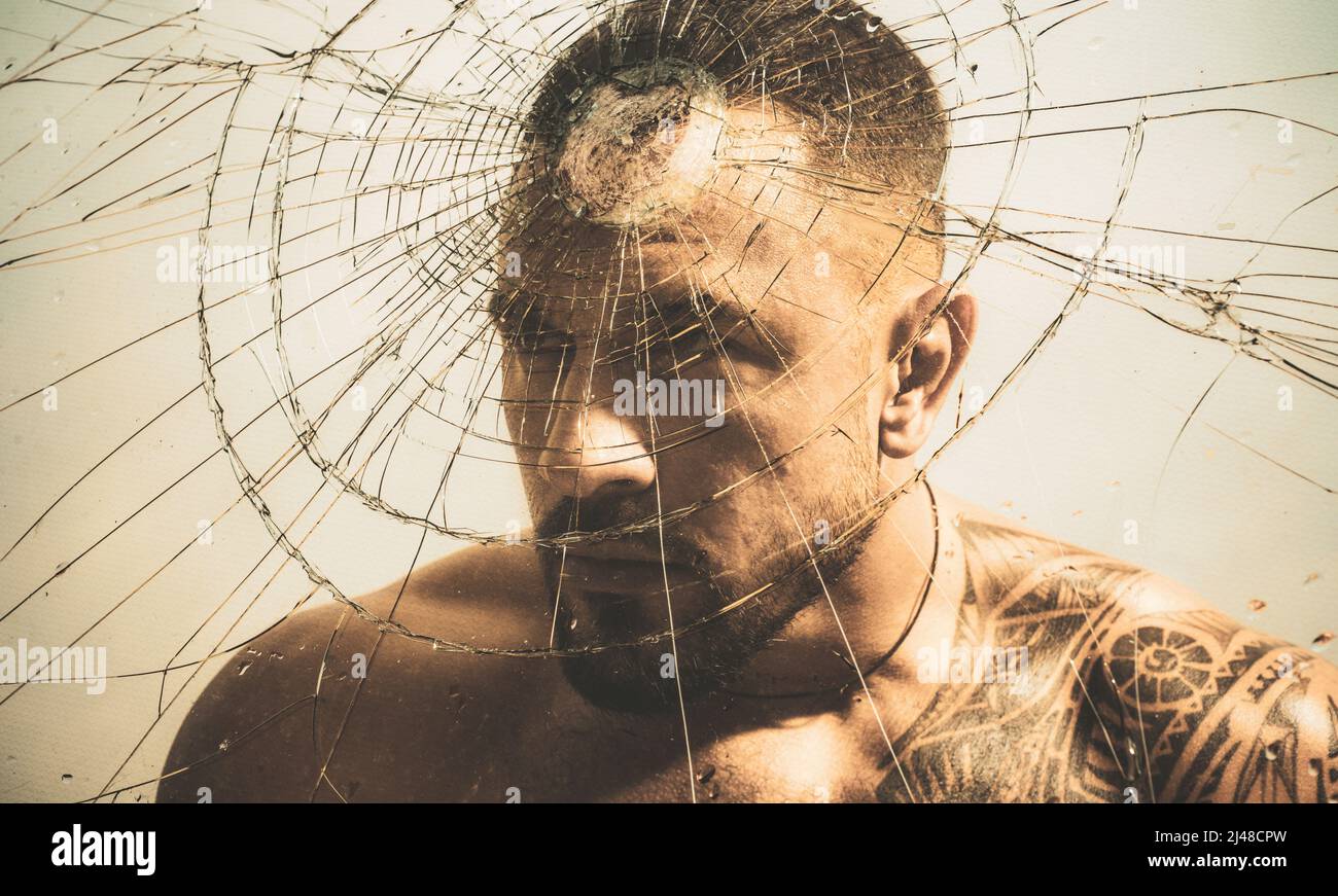 Overcoming the obstacle. Determined man knocking down a glass wall with ...