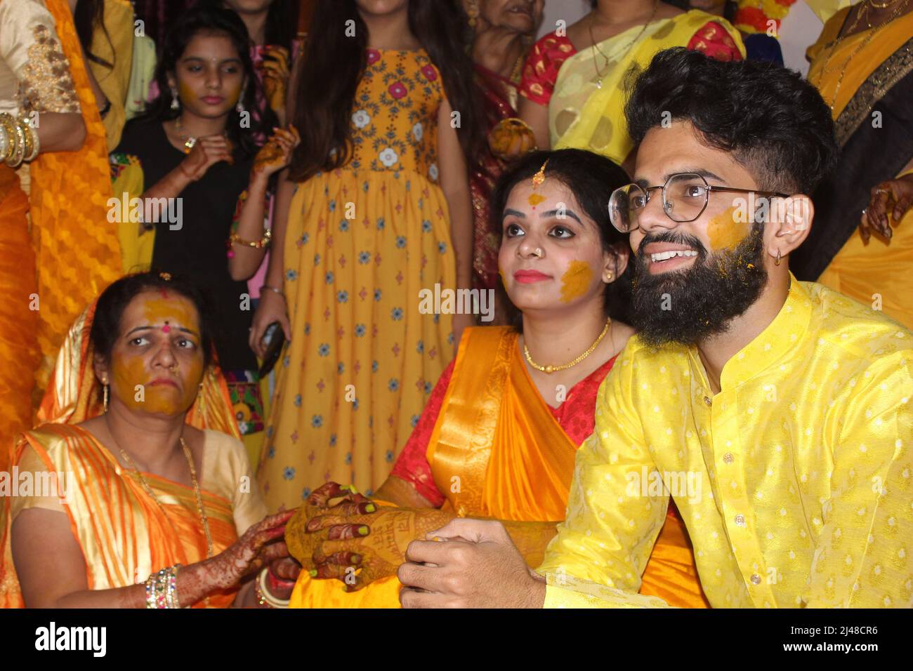 Indian Hindu bride with turmeric paste applied on her face having fun ...