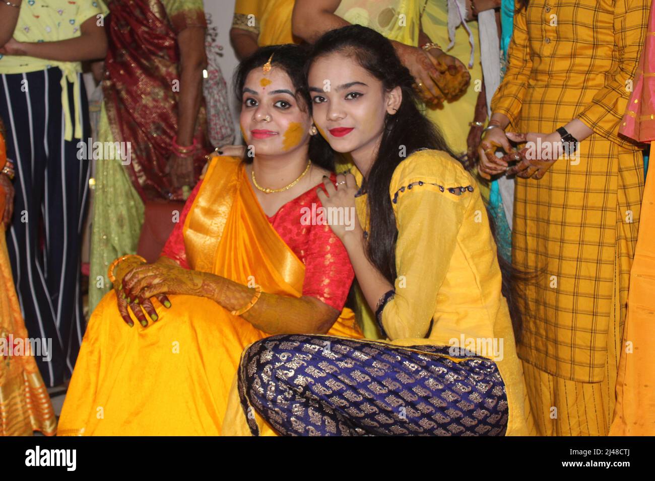 Indian Hindu bride with turmeric paste applied on her face having fun ...