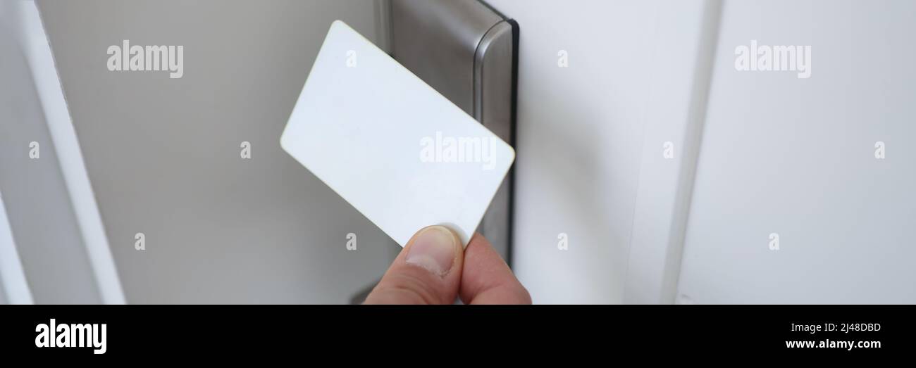 Male hand putting key card to lock on door closeup Stock Photo - Alamy