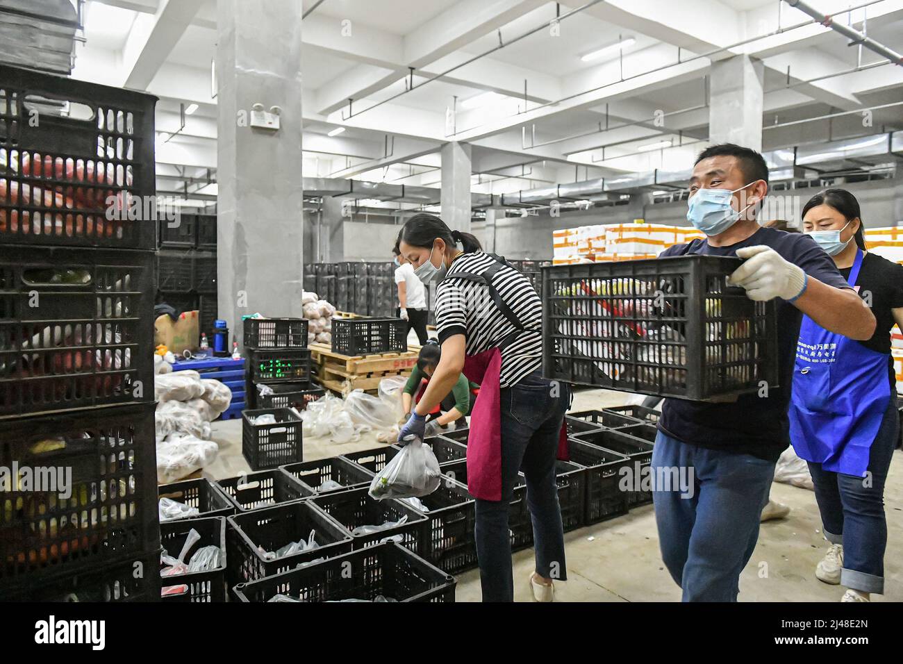 HEFEI, CHINA - APRIL 12, 2022 - People work overnight to sort and pack ...