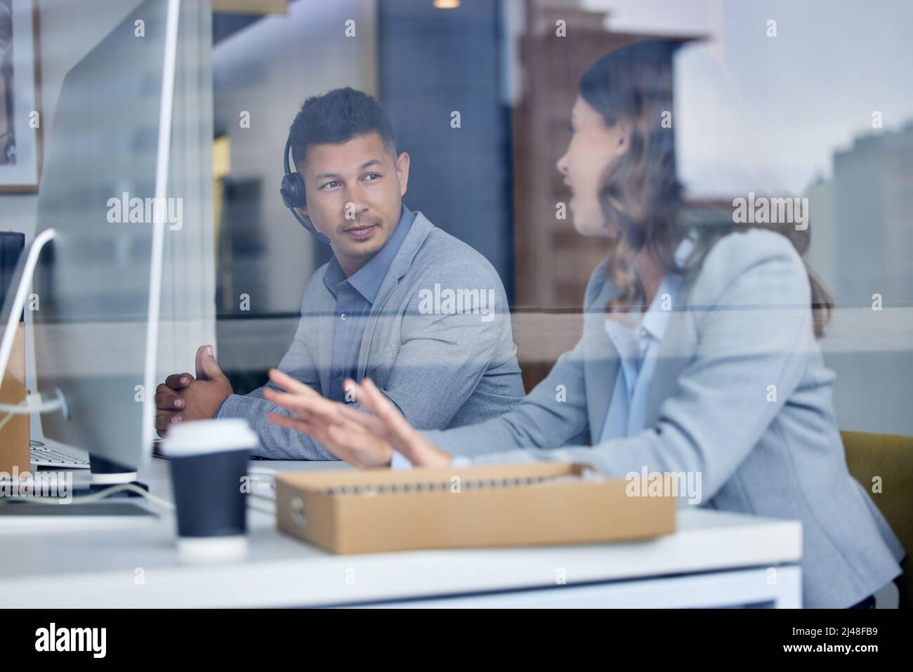 Helping a colleague is as important as helping a client. Cropped shot ...