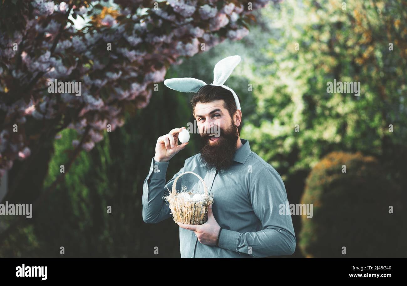 Funny man in rabbit costume with easter eggs Stock Photo - Alamy