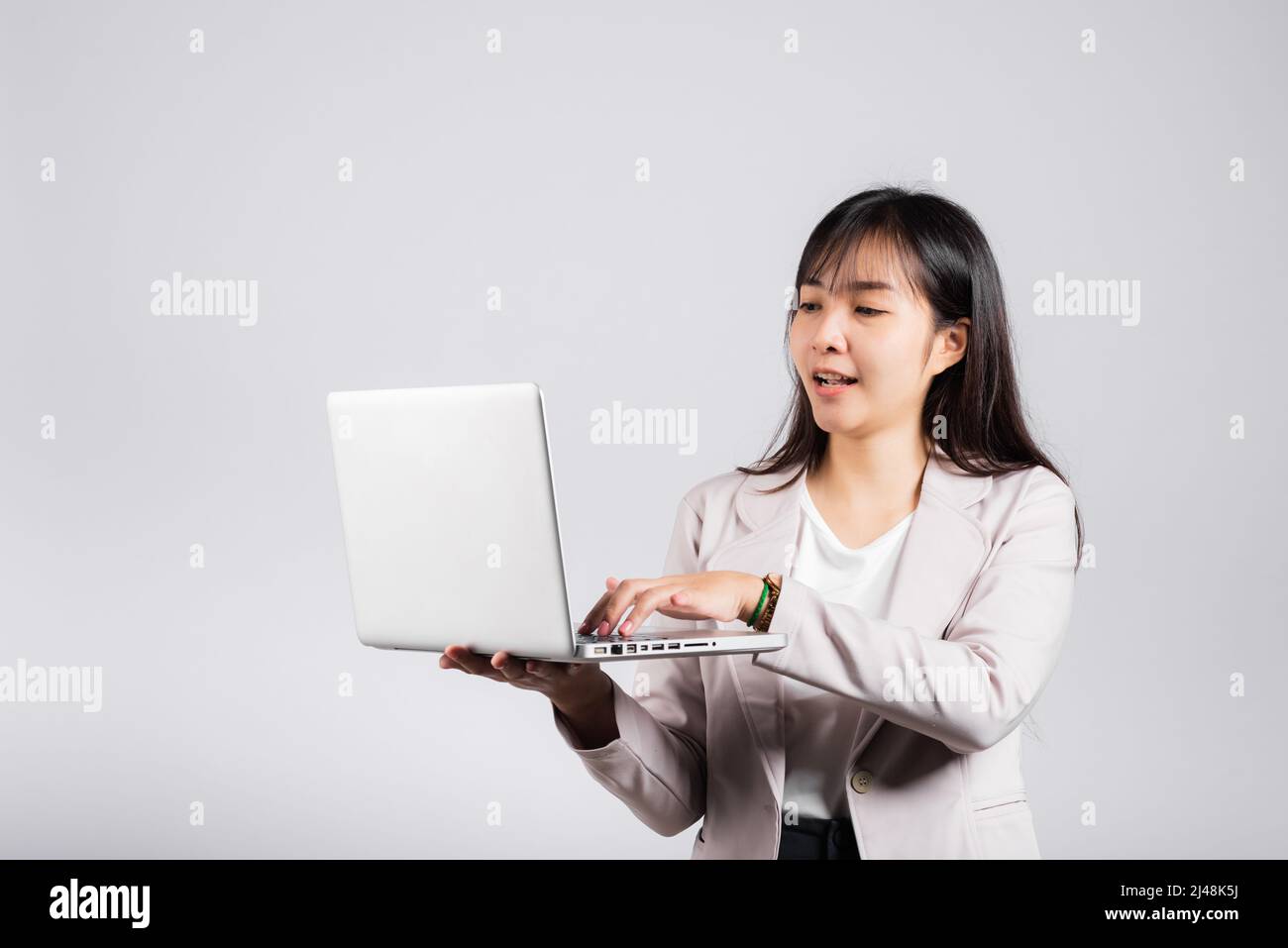 Woman smiling confident smiling holding using laptop computer and ...