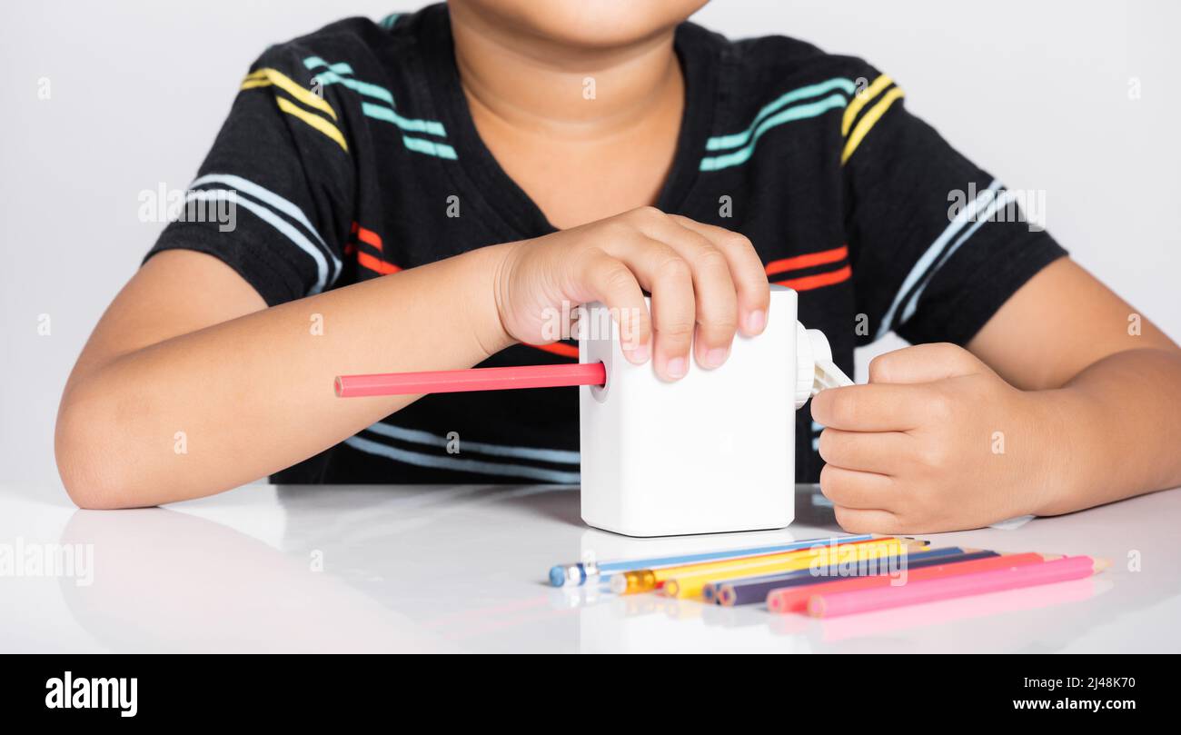 Little cute kid boy 5-6 years old smile using pencil sharpener while ...