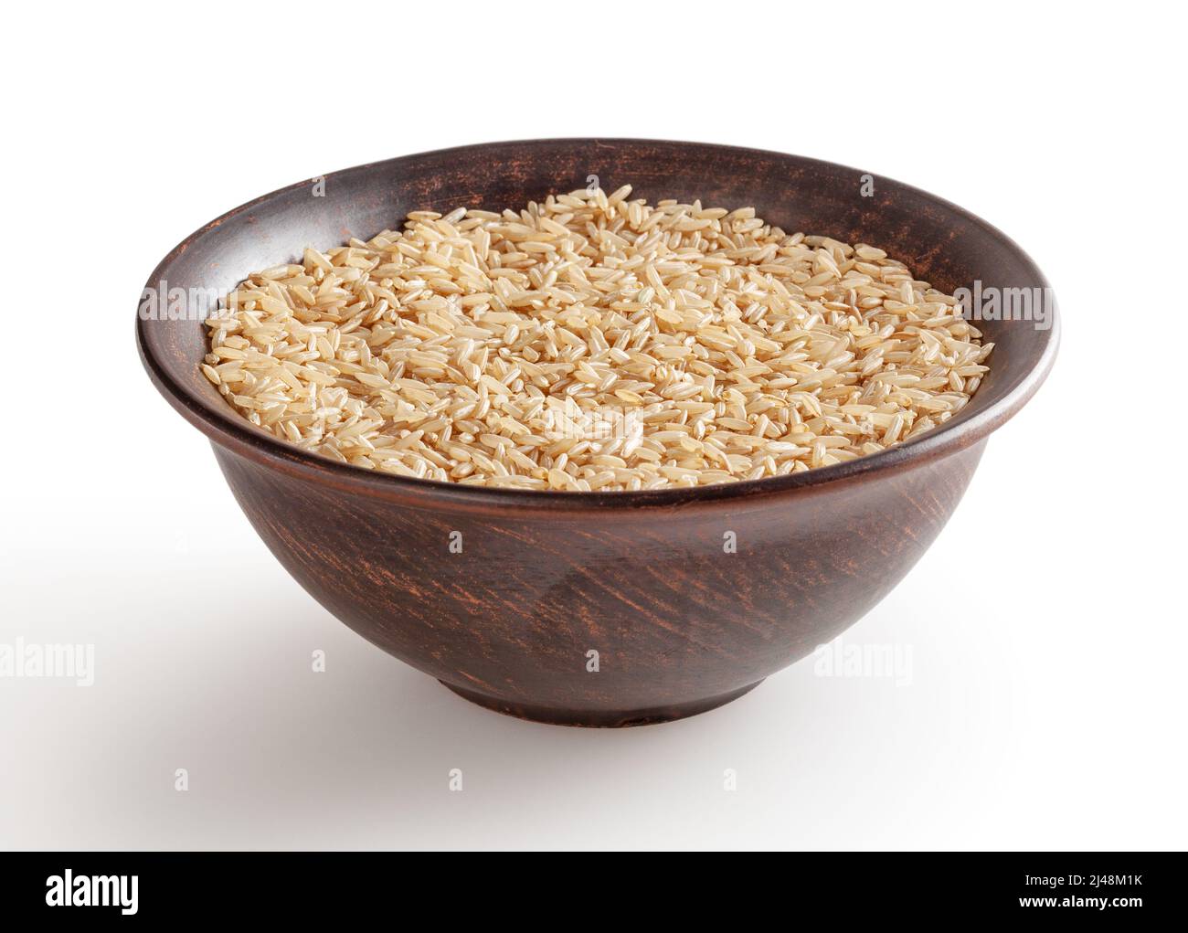 Brown rice in ceramic bowl isolated on white background with clipping ...