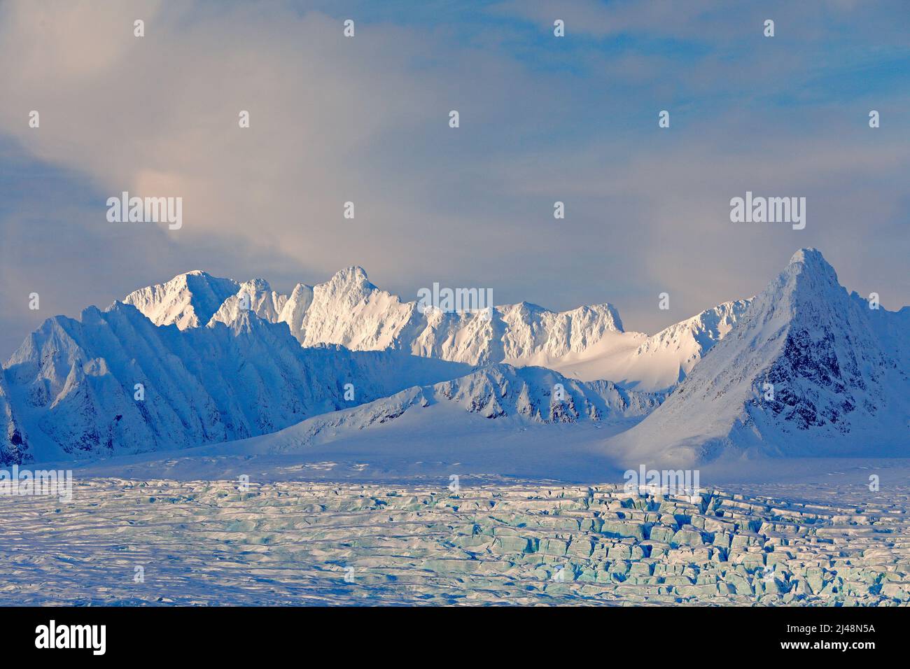 Land of ice. Travelling in Arctic Norway. White snowy mountain, blue ...