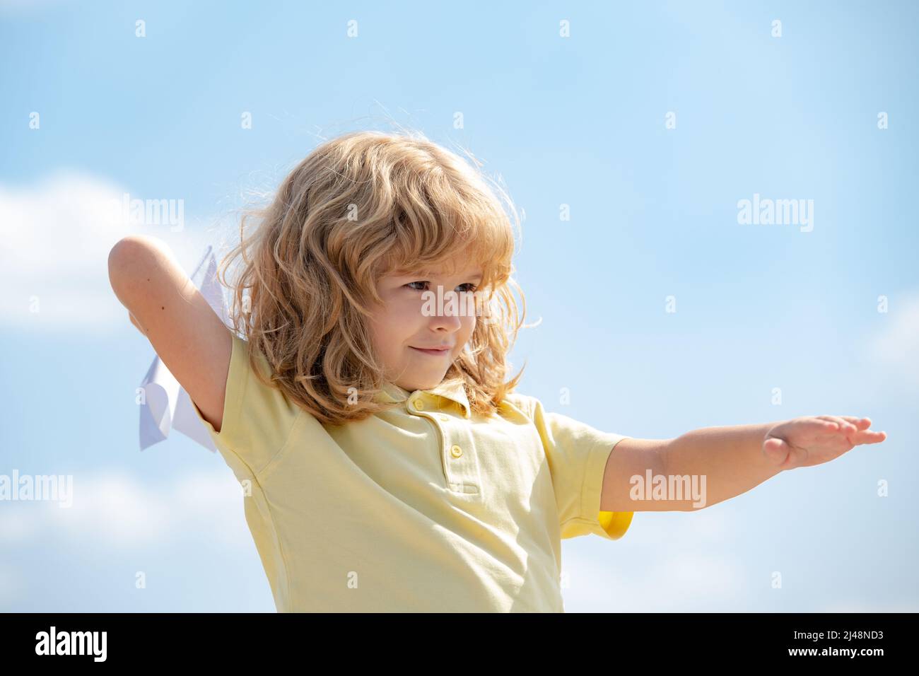Kid dreaming and plays with a toy plane in the park. Dreams of travel ...