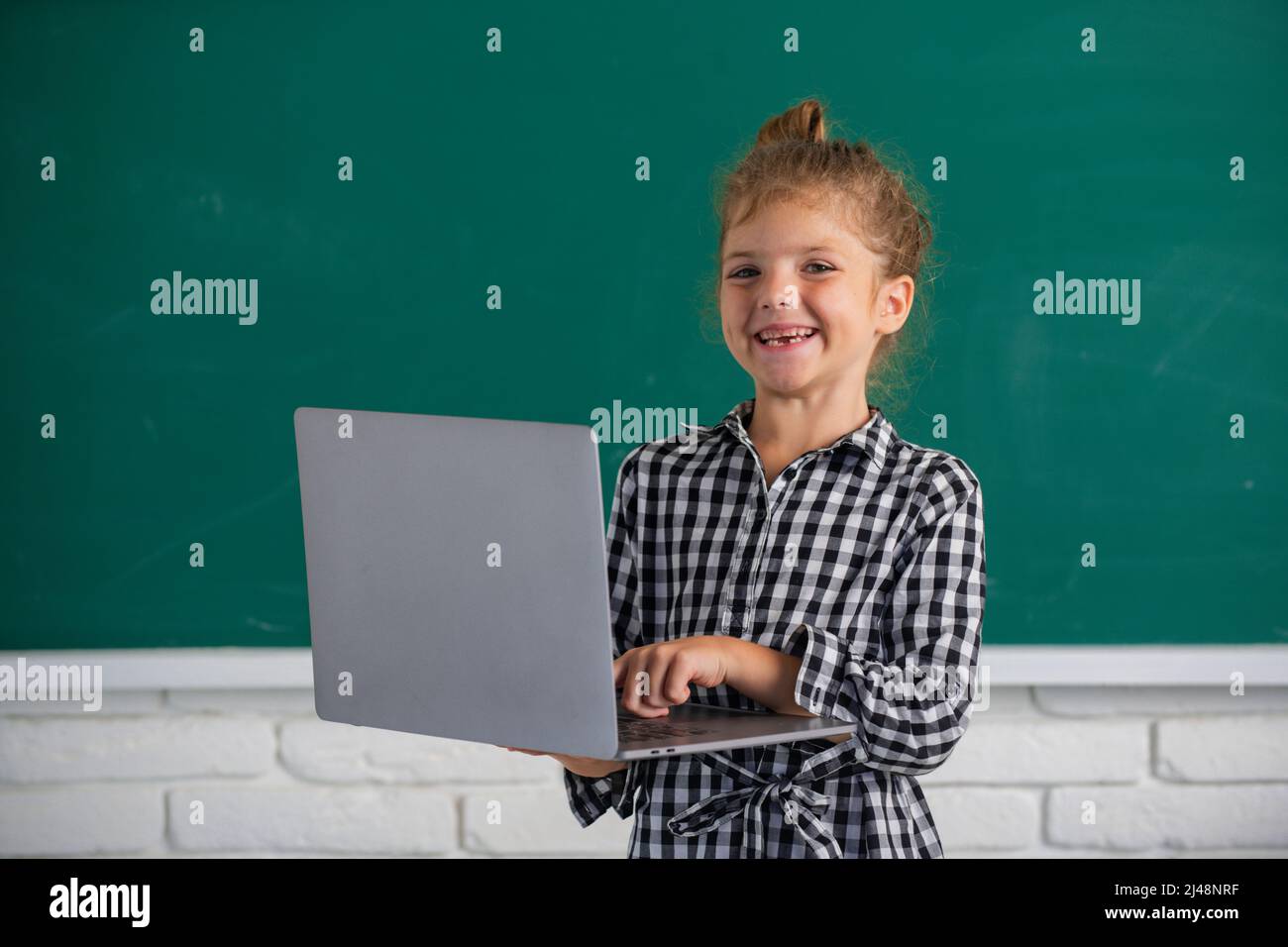 Child girl using gadgets to study. Computer education for kids Stock ...
