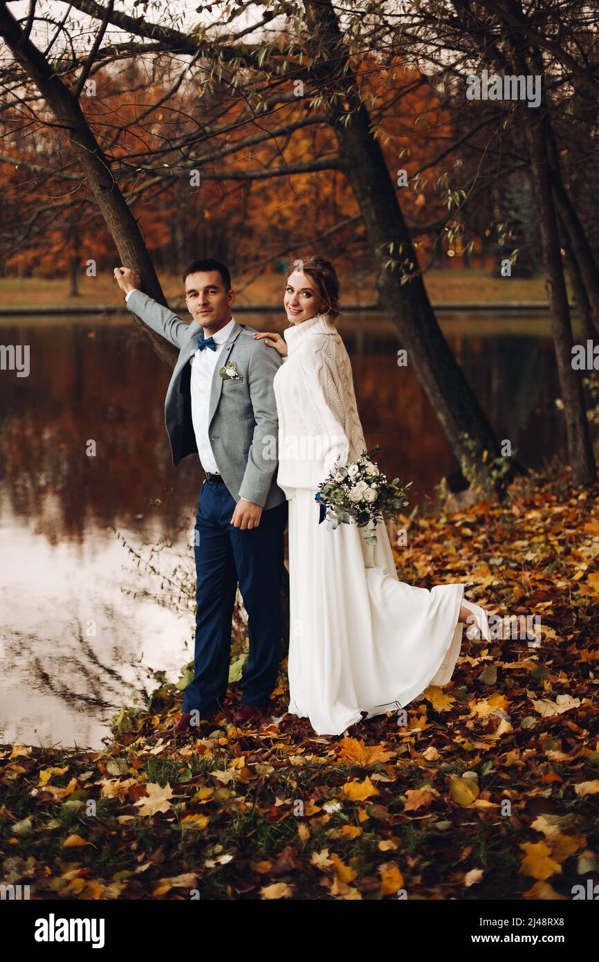 Beloved couple standing ar lake pear, embracing and kissing Stock Photo ...