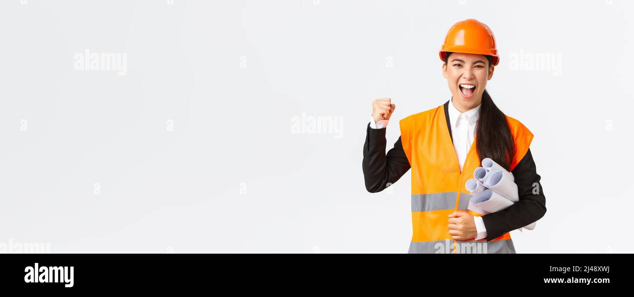 Successful female asian engineer, architect in safety helmet and ...