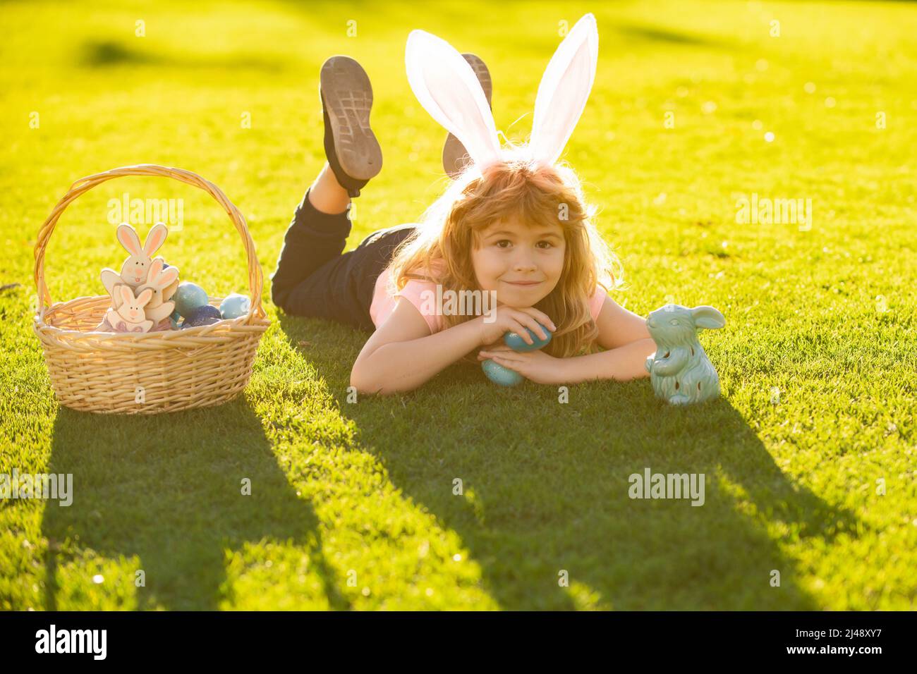 Happy Easter. Child boy with easter eggs and bunny ears outdoor. Cute ...