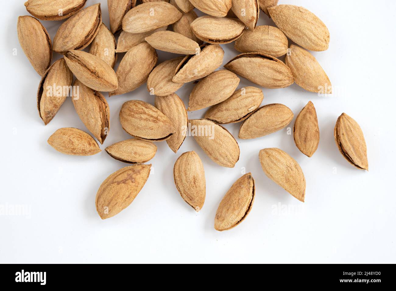top view of unpeeled almonds drupes isolated on white background ...