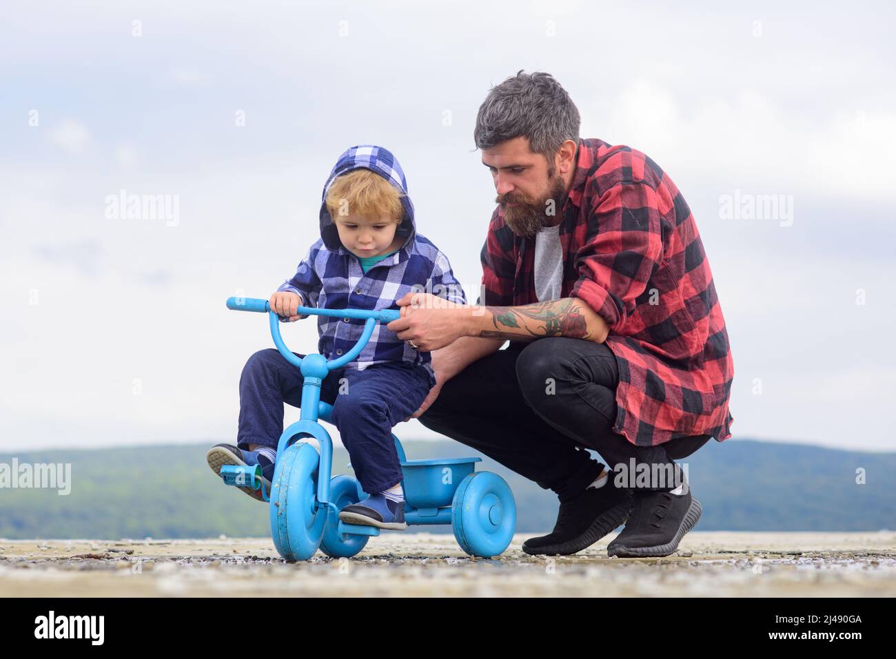 Little boy learn to ride a bike with his daddy. Dad teaching son to ...