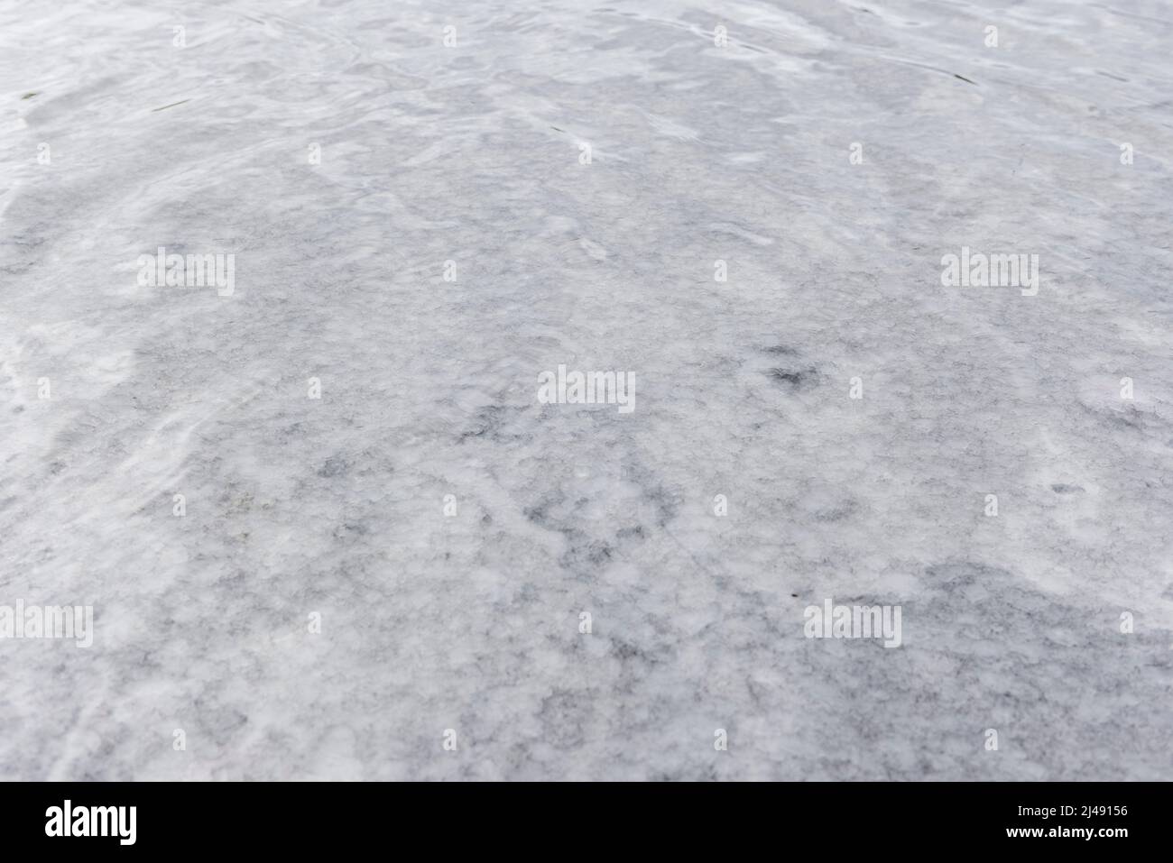 Shallow water covered with salt crystals at the Jan Thiel Salt Flats on ...