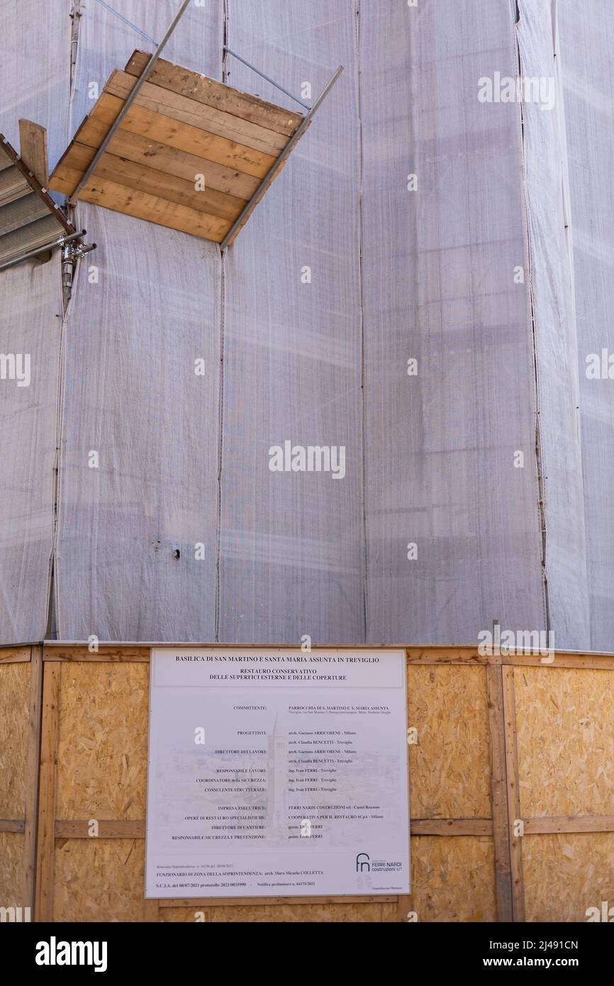 a building at a construction site covered with fabric and scaffolding ...