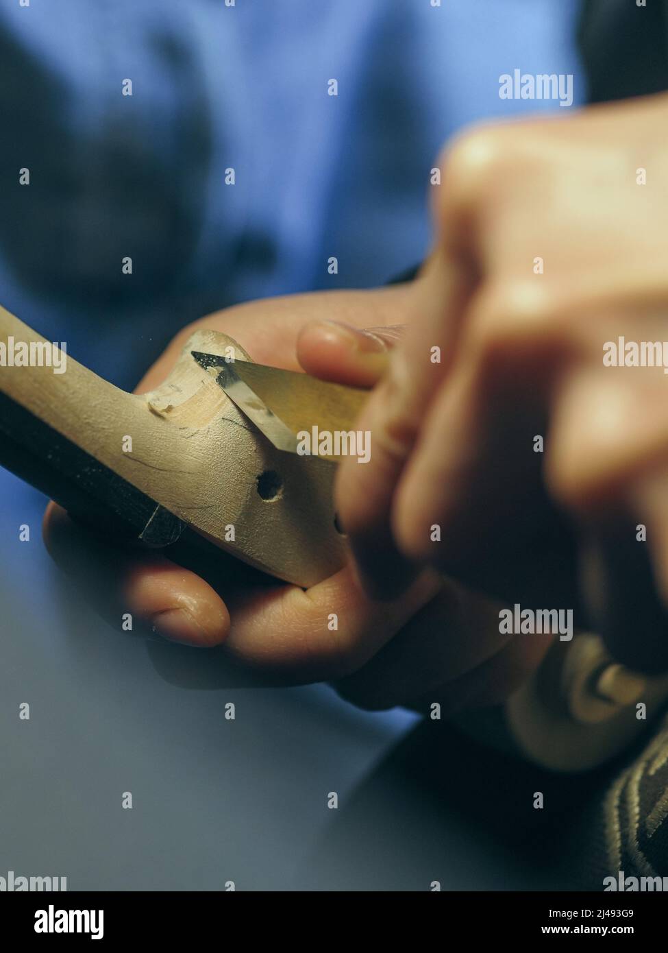 Luthier at work with a violin scroll in his workshop Stock Photo - Alamy