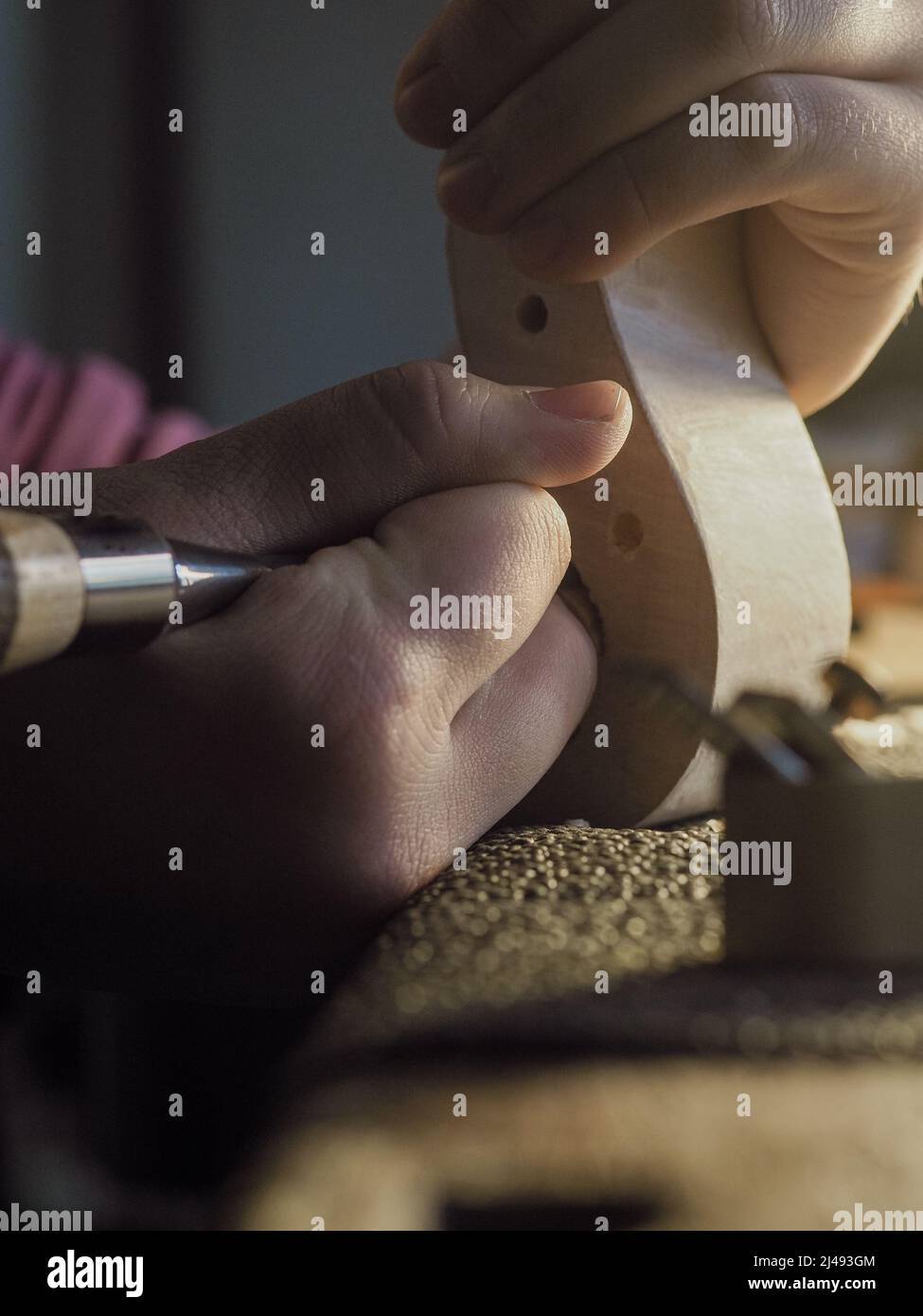 Luthier at work with a violin scroll in his workshop Stock Photo - Alamy