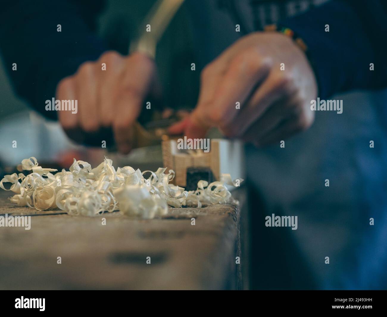 Luthier at work with a violin scroll in his workshop Stock Photo - Alamy