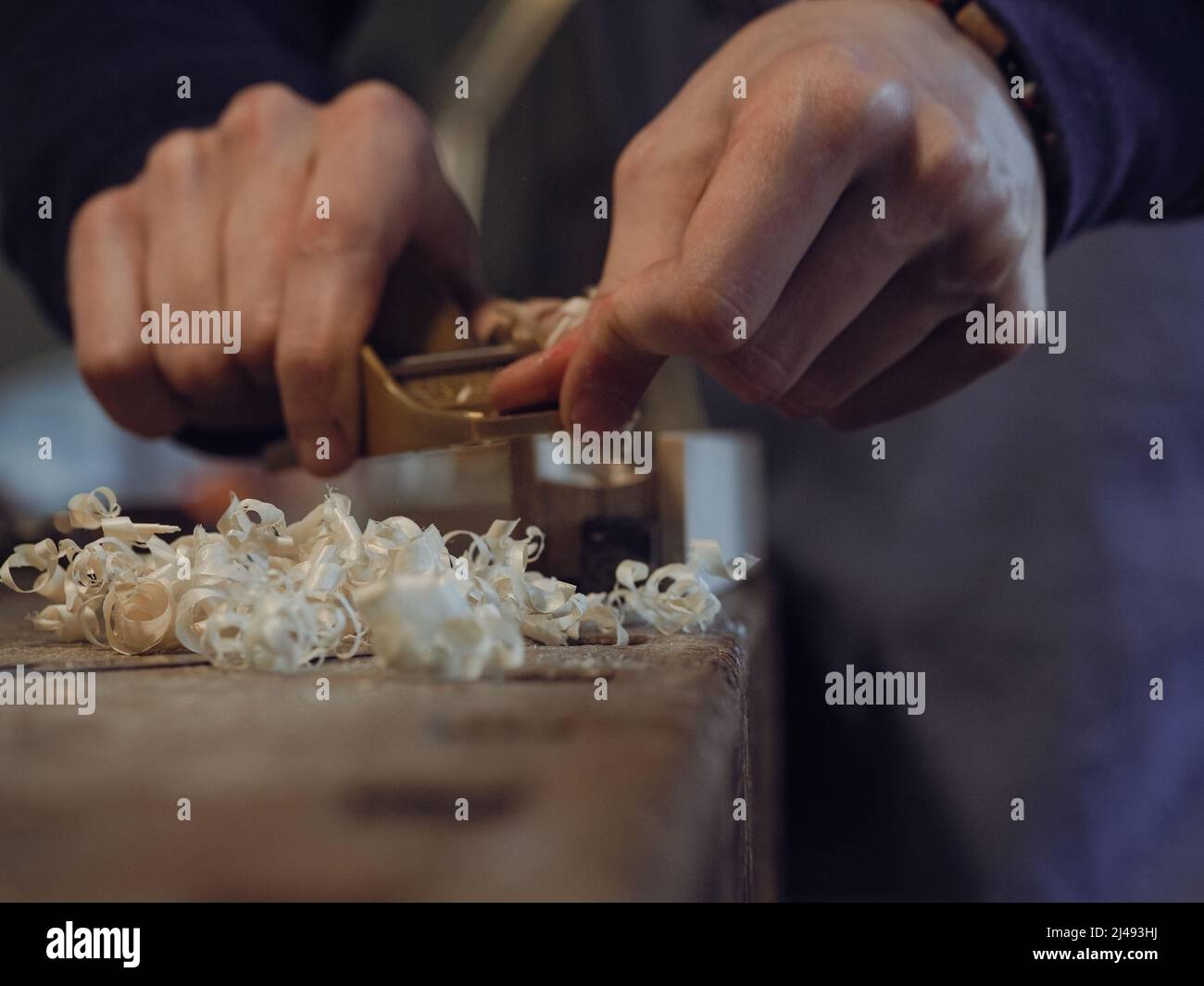 Luthier at work with a violin scroll in his workshop Stock Photo - Alamy