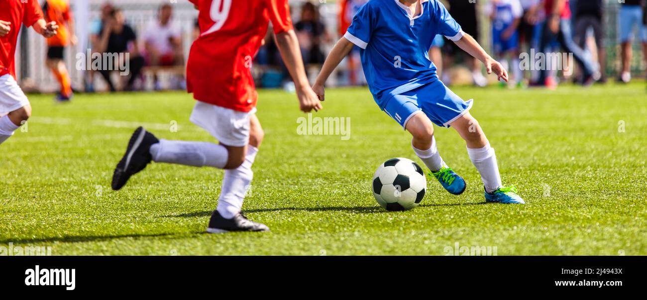 Boys play soccer. Teenagers playing soccer in sports field. Children ...
