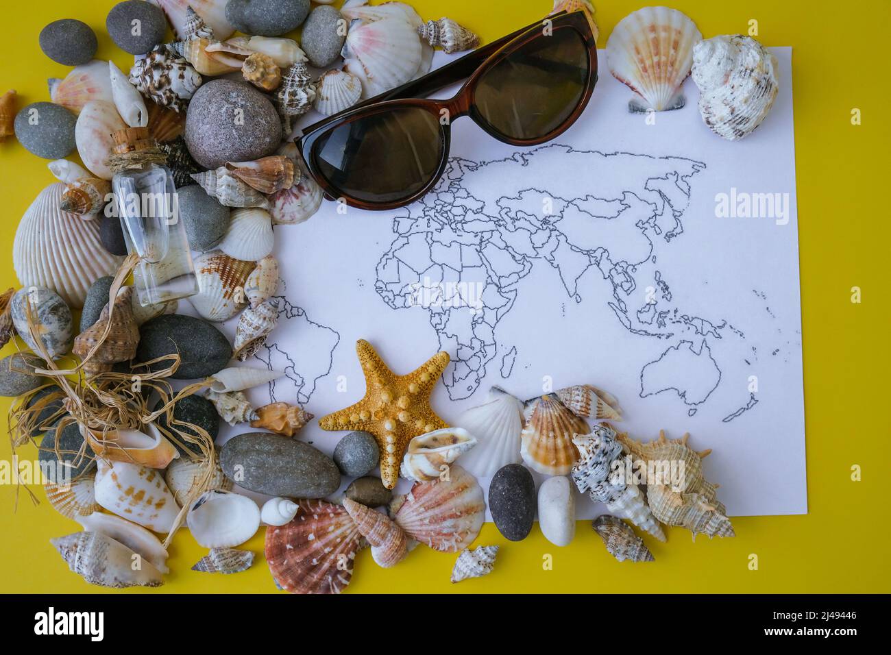World map, seashells and pebbles boarding pass. Travel vacation concept ...