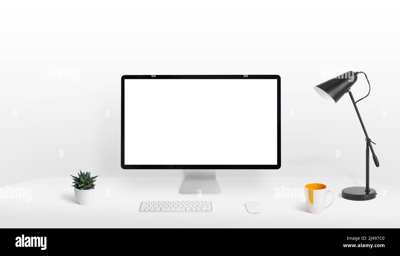 Computer display mockup on work desk. Blank, white, isolated screen for ...