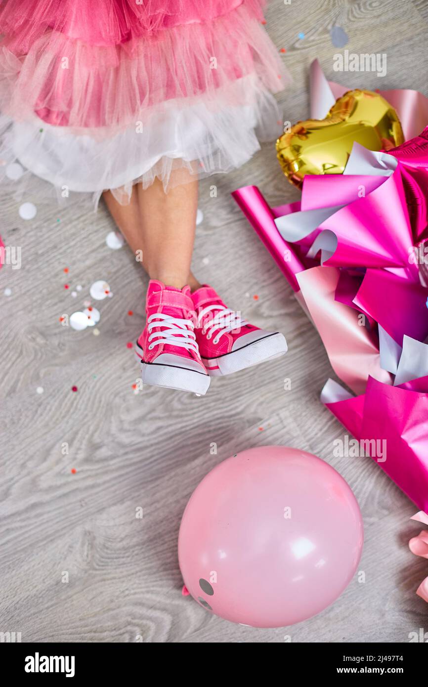 Creative lay out of funky leg of girl in pink sneakers and dress, flat ...