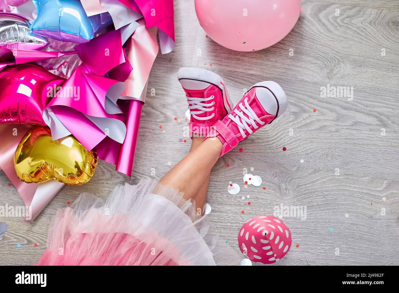 Creative lay out of funky leg of girl in pink sneakers and dress, flat ...
