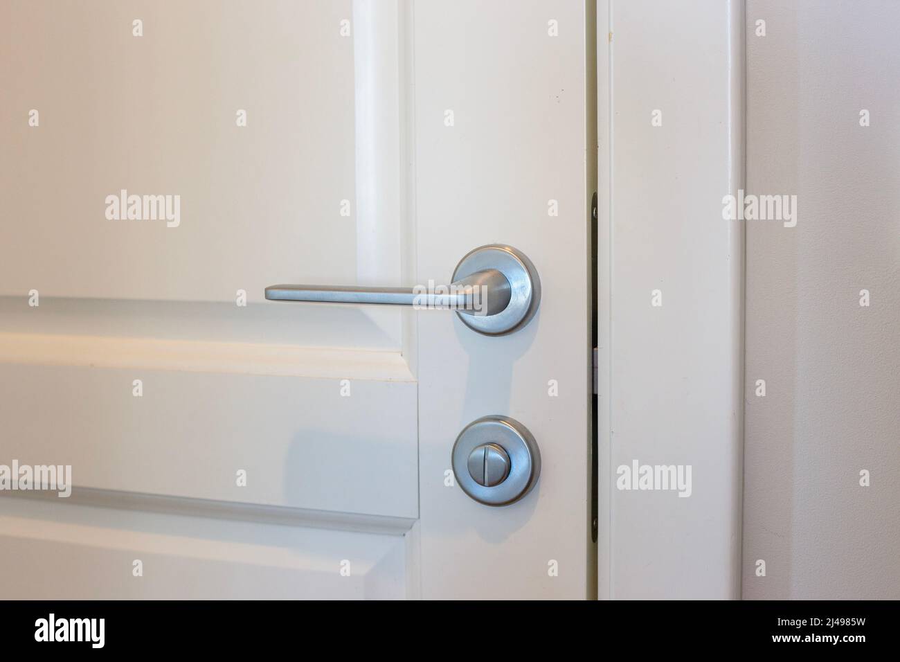White door and silver doorknob in the apartment Stock Photo - Alamy