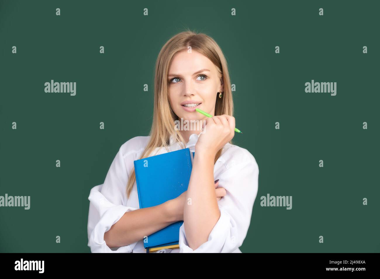 Portrait of young cute blonde female college student studying in ...