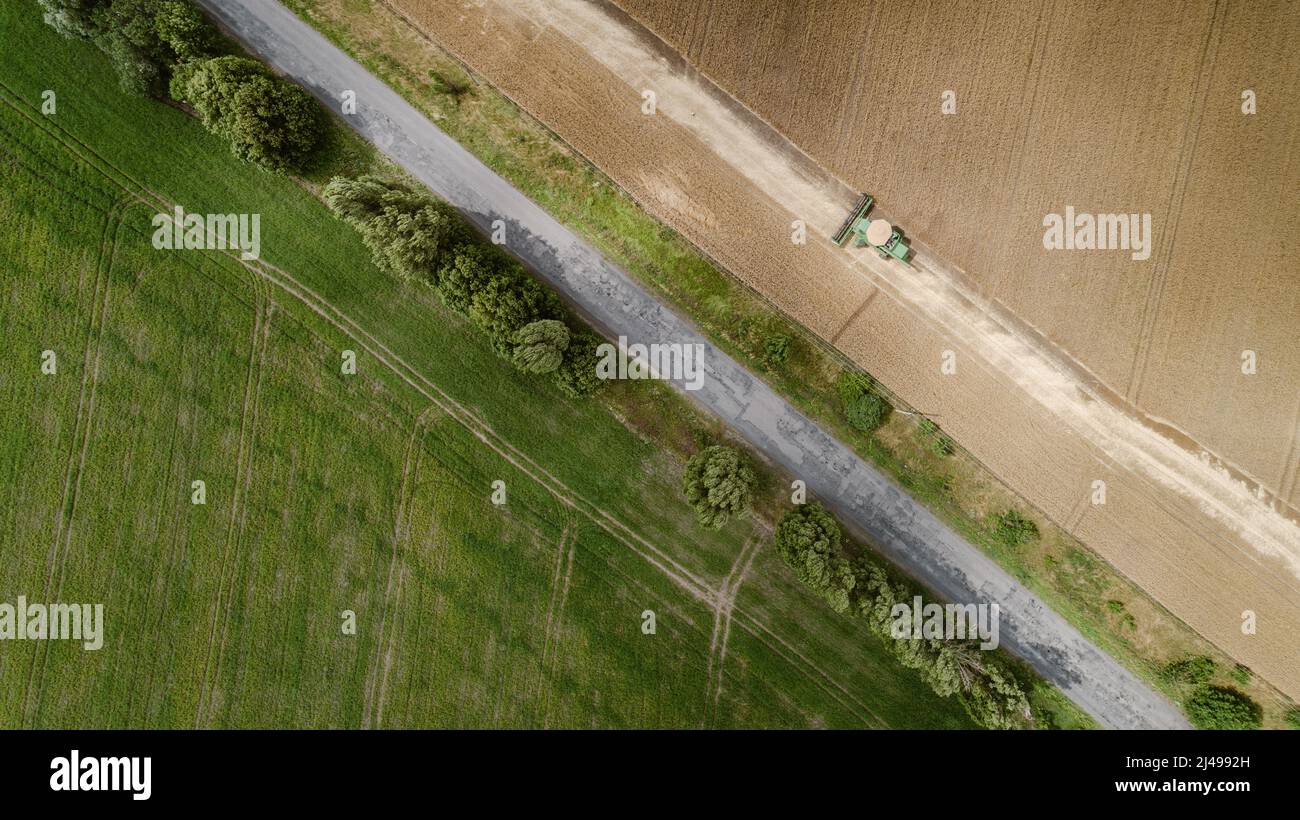 Aerial view combine harvester harvesting on the field Stock Photo - Alamy