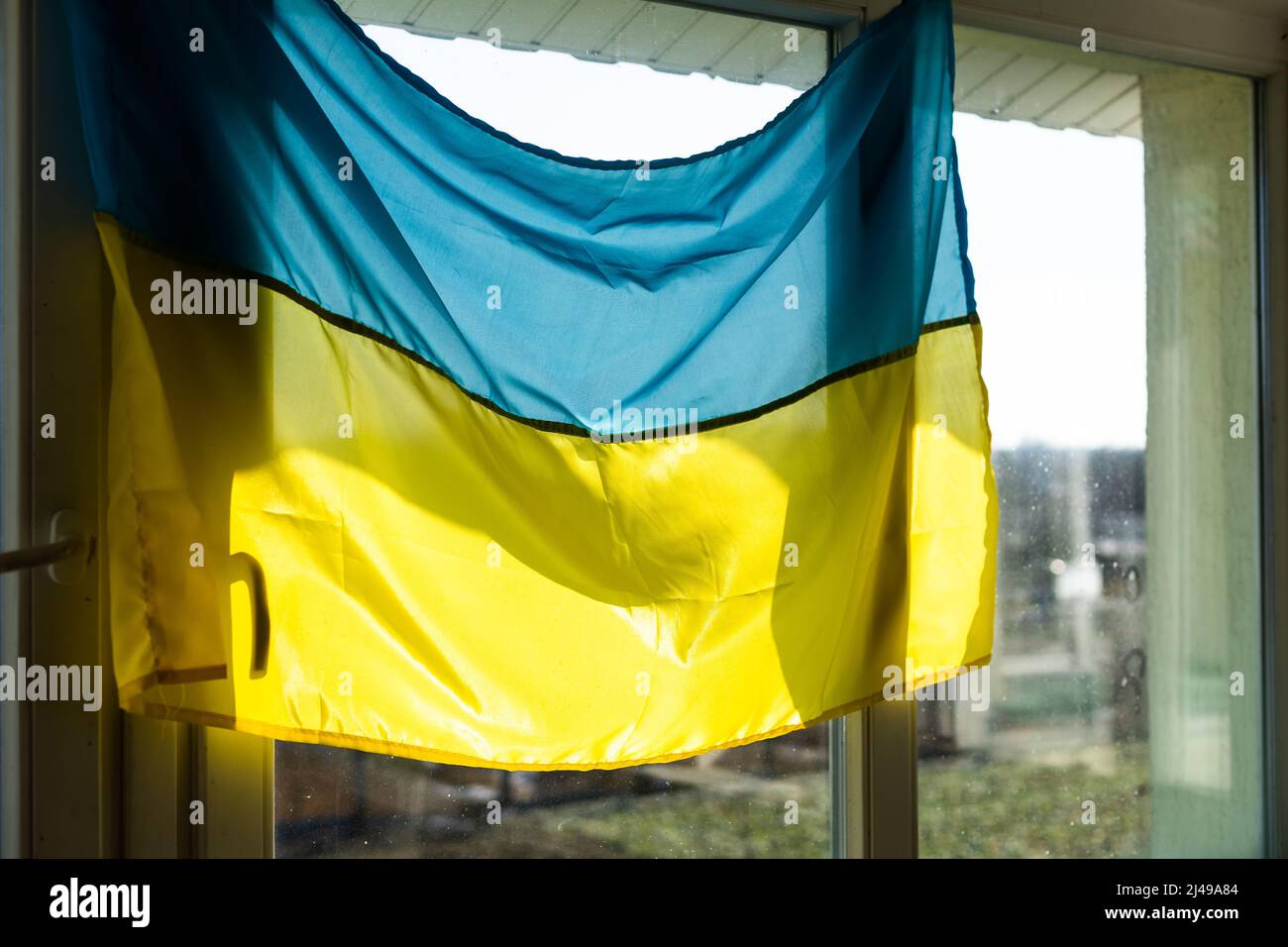 Support Ukraine. Ukrainian flag on the window. Place for text Stock ...