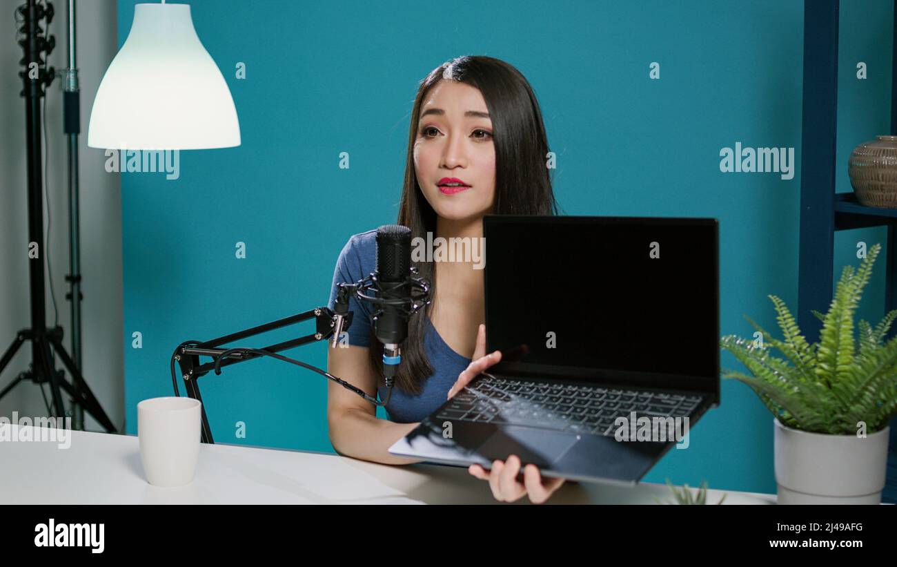 Asian woman reviewing laptop computer on social media podcast ...