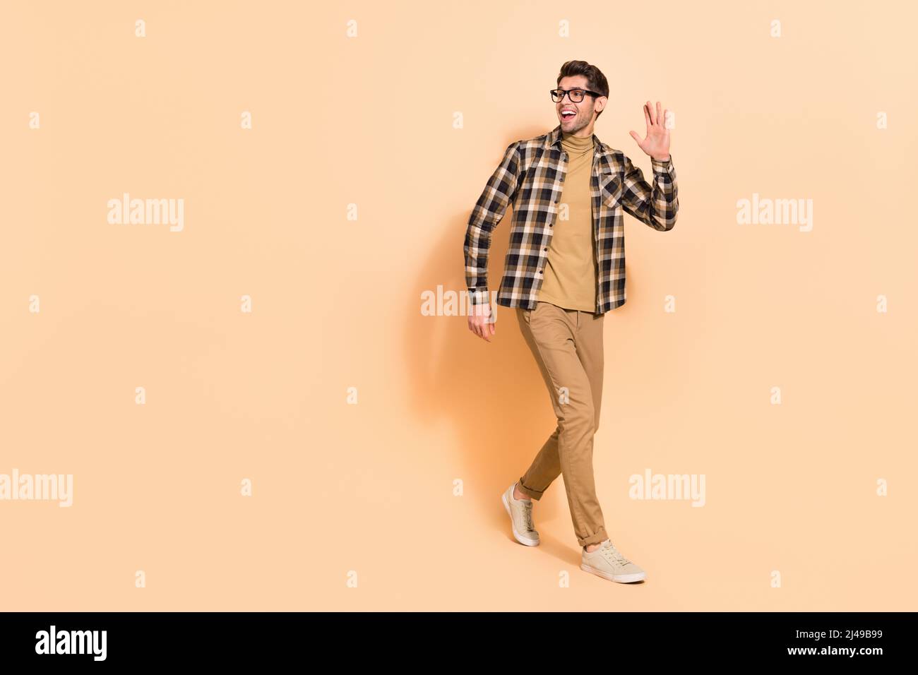 Full length body size view of attractive cheerful guy walking waving hi ...