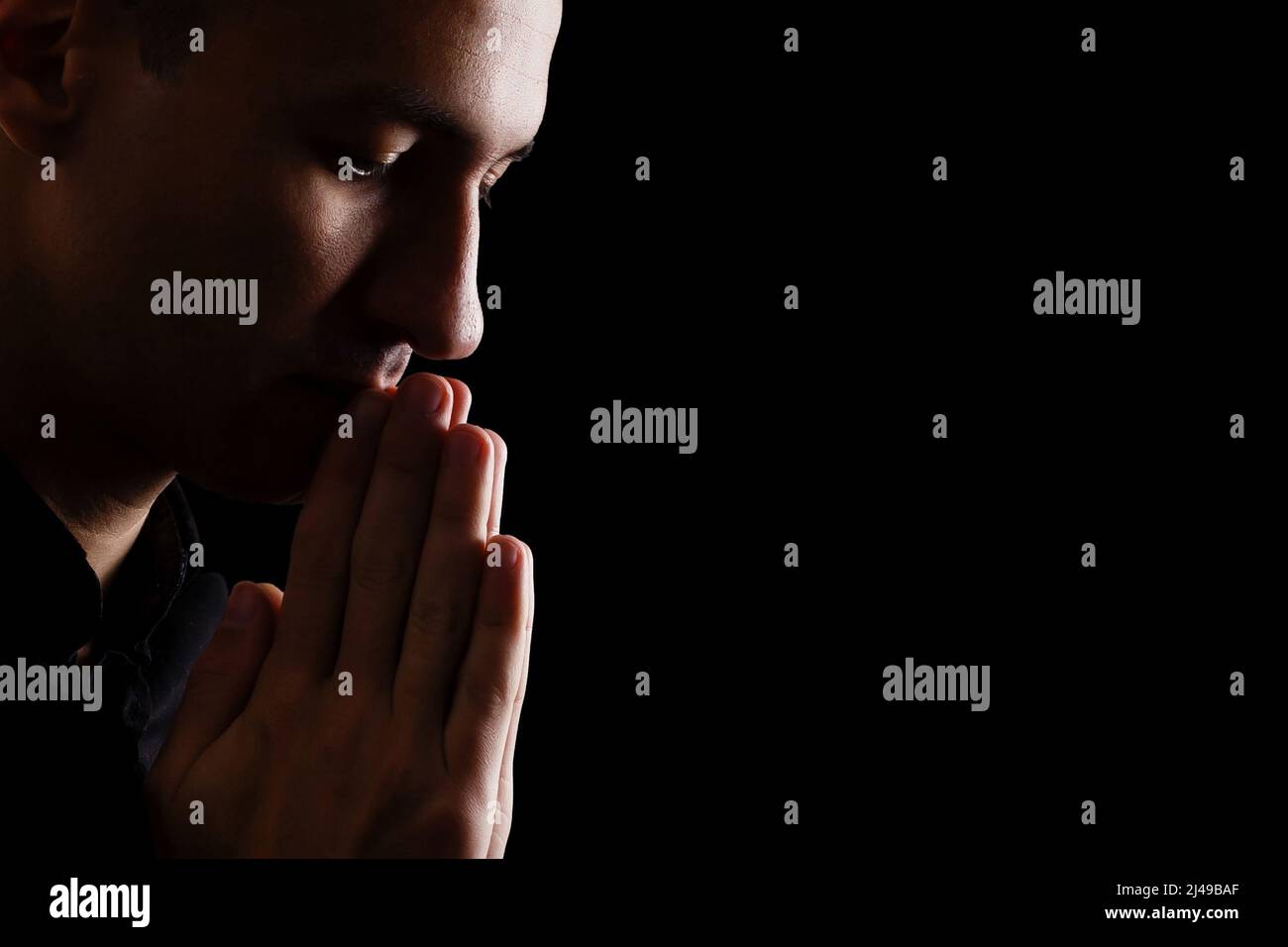 prayer on a dark background Stock Photo - Alamy