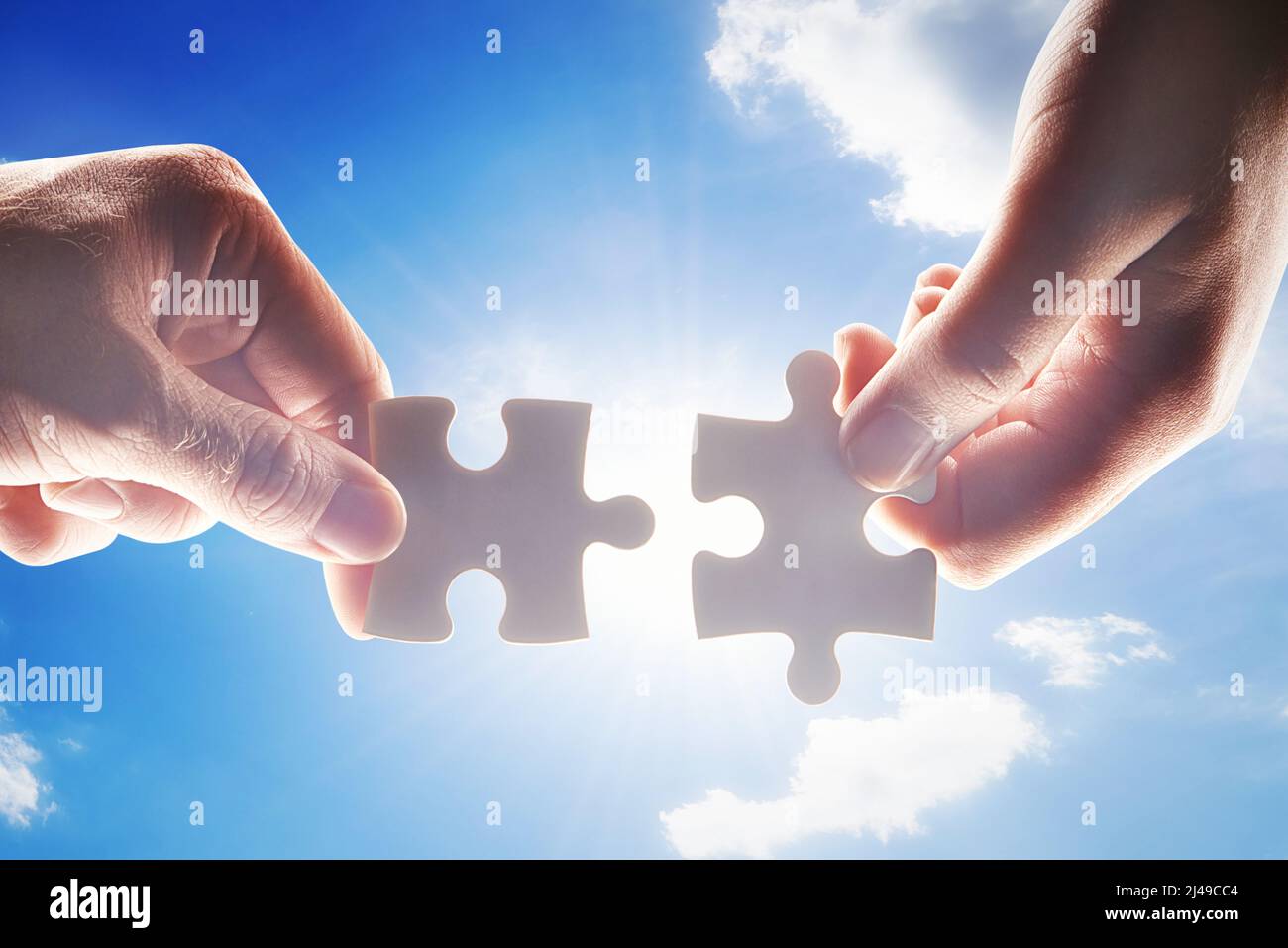 Connecting the pieces. Cropped shot of hands holding two puzzle pieces ...