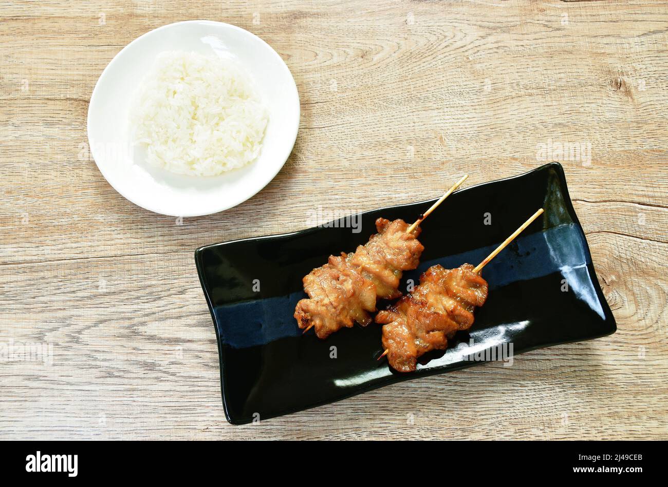 grilled pork in wooden stick eat with sticky rice on dish Stock Photo ...