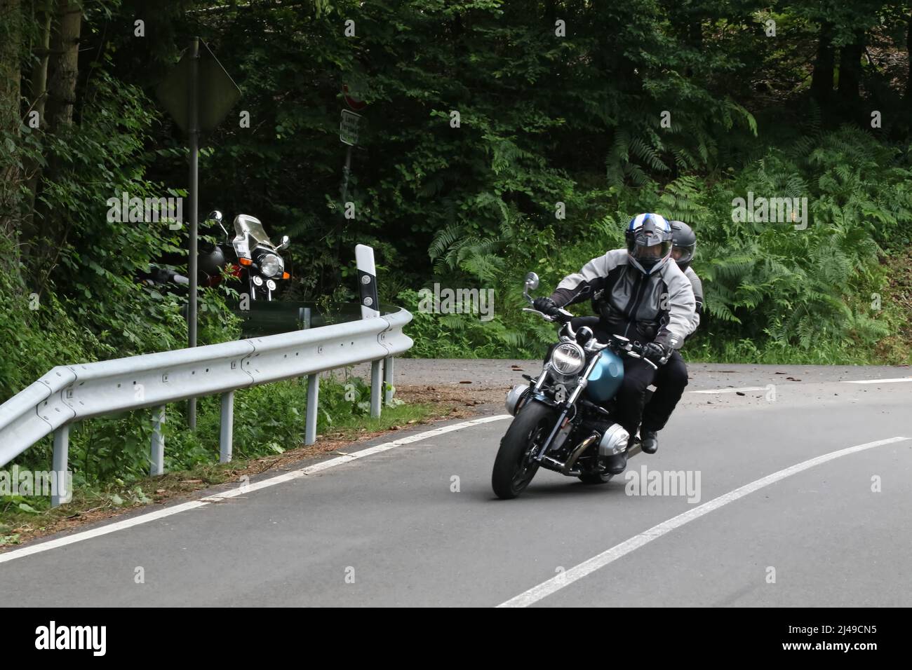 motorcycle on a road passing another bike Stock Photo - Alamy