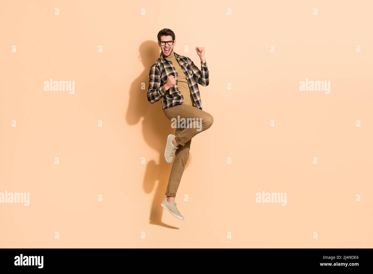 Full length body size view of attractive cheerful guy jumping dancing ...