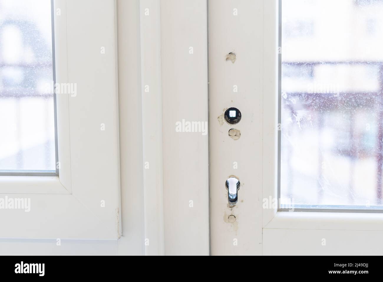 Worker man installs plastic windows and doors with double-glazed white ...