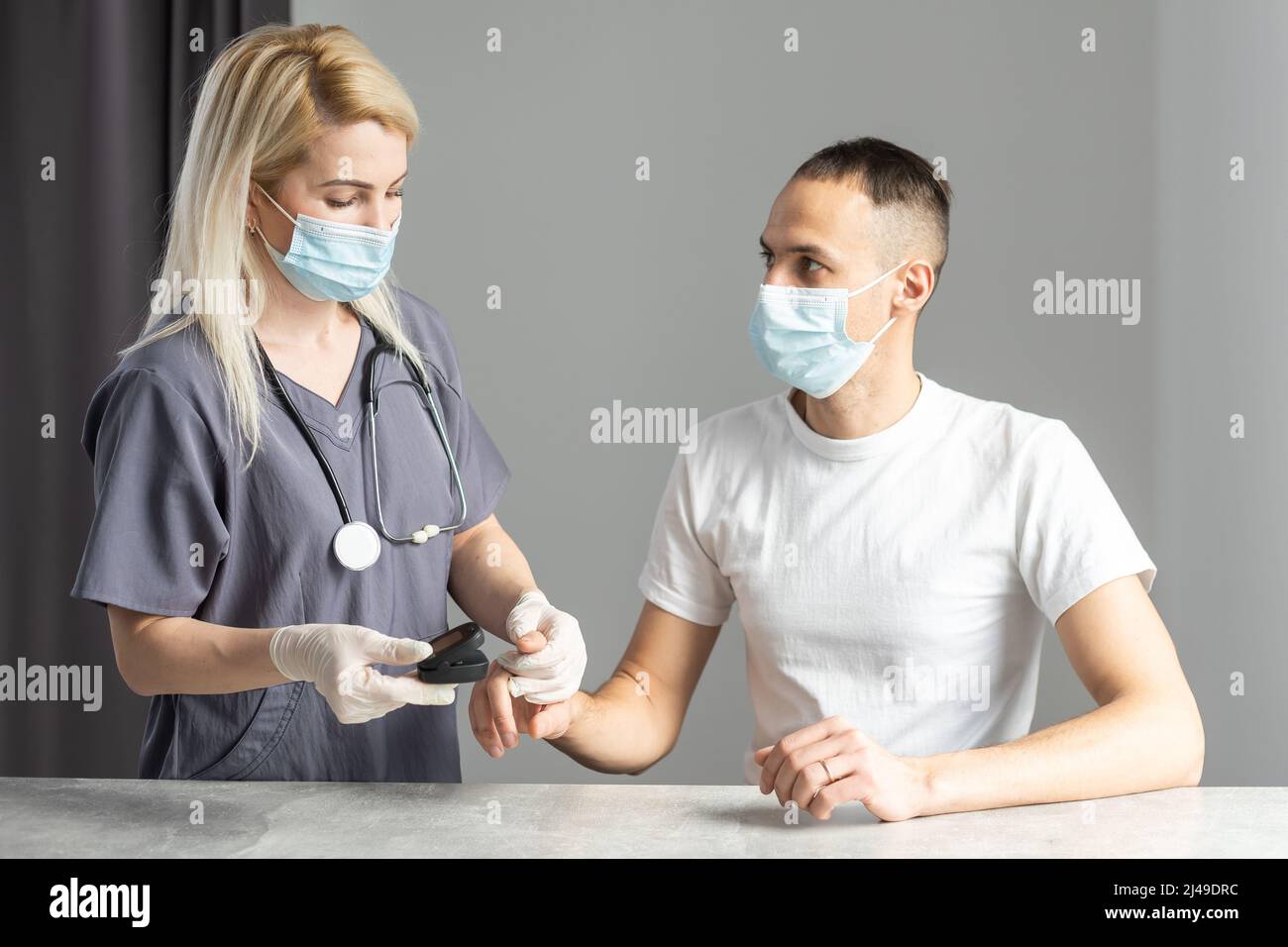 Doctor checking oxygenation with fingertip pulse oximeter. Saturation ...