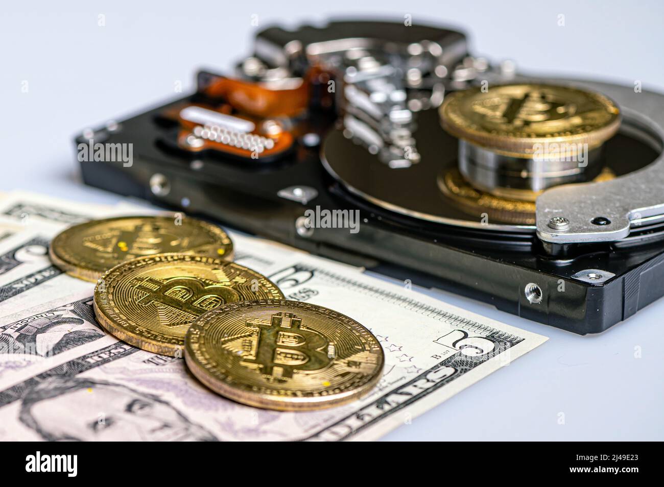Bitcoin BTC coins, open hard drive and dollar bills, cryptocurrency and ...