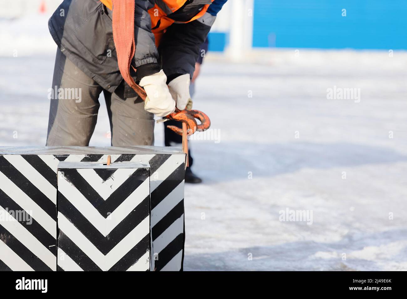 Slinger in work clothes hooks control load with hook. Authentic scene ...