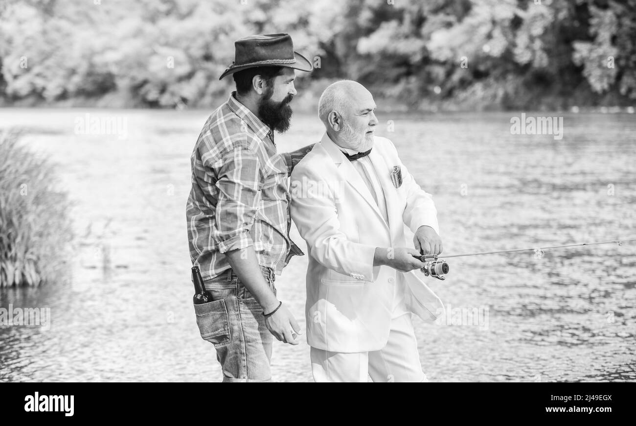 family values. two fishermen with fishing reel. retired businessman ...