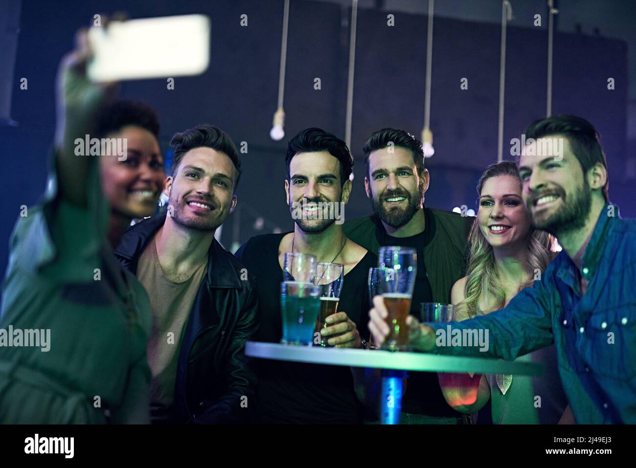 Remembering an awesome night out. Shot of a group of young friends ...